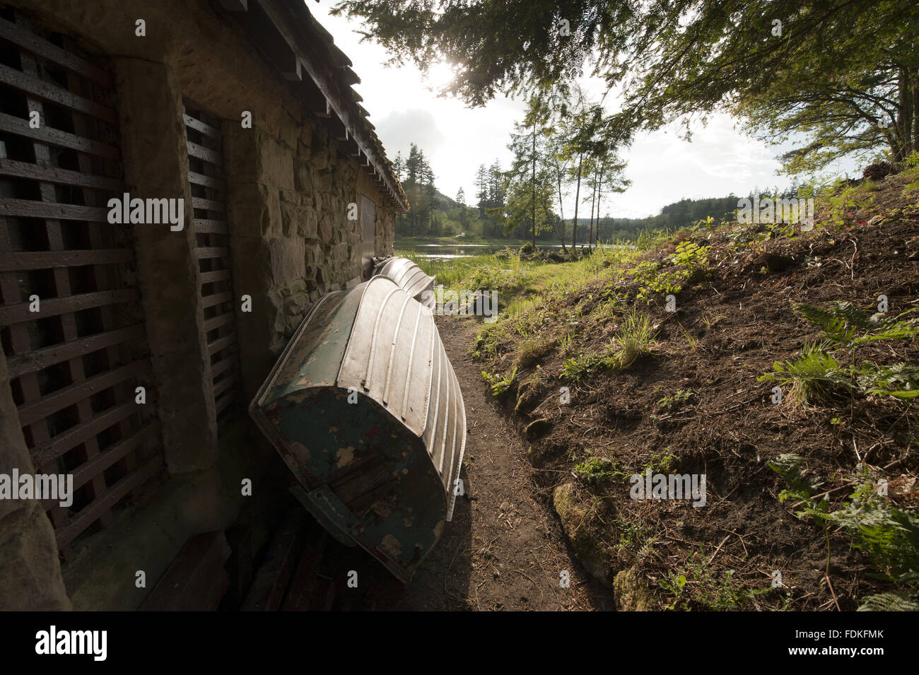 Boats leaning against the boathouse by the lake at Cragside ...