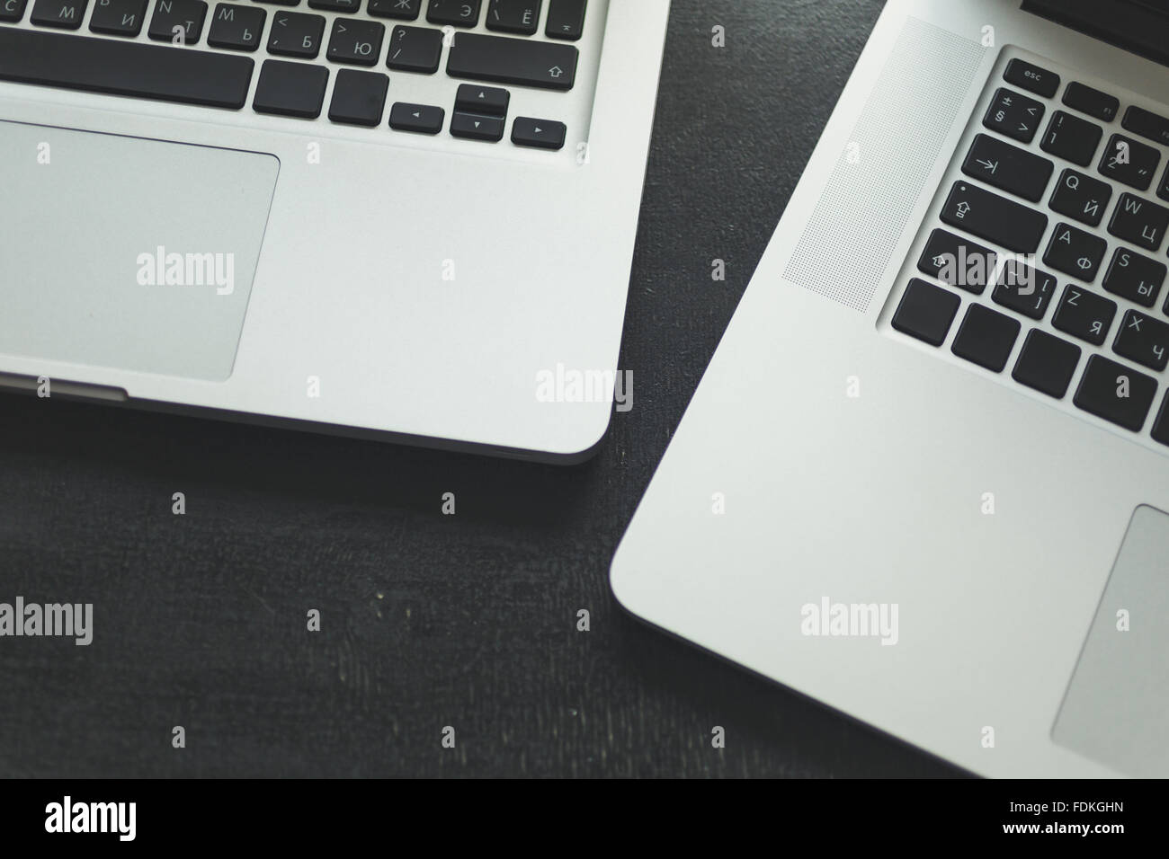 Two laptops on modern wooden desk Stock Photo - Alamy