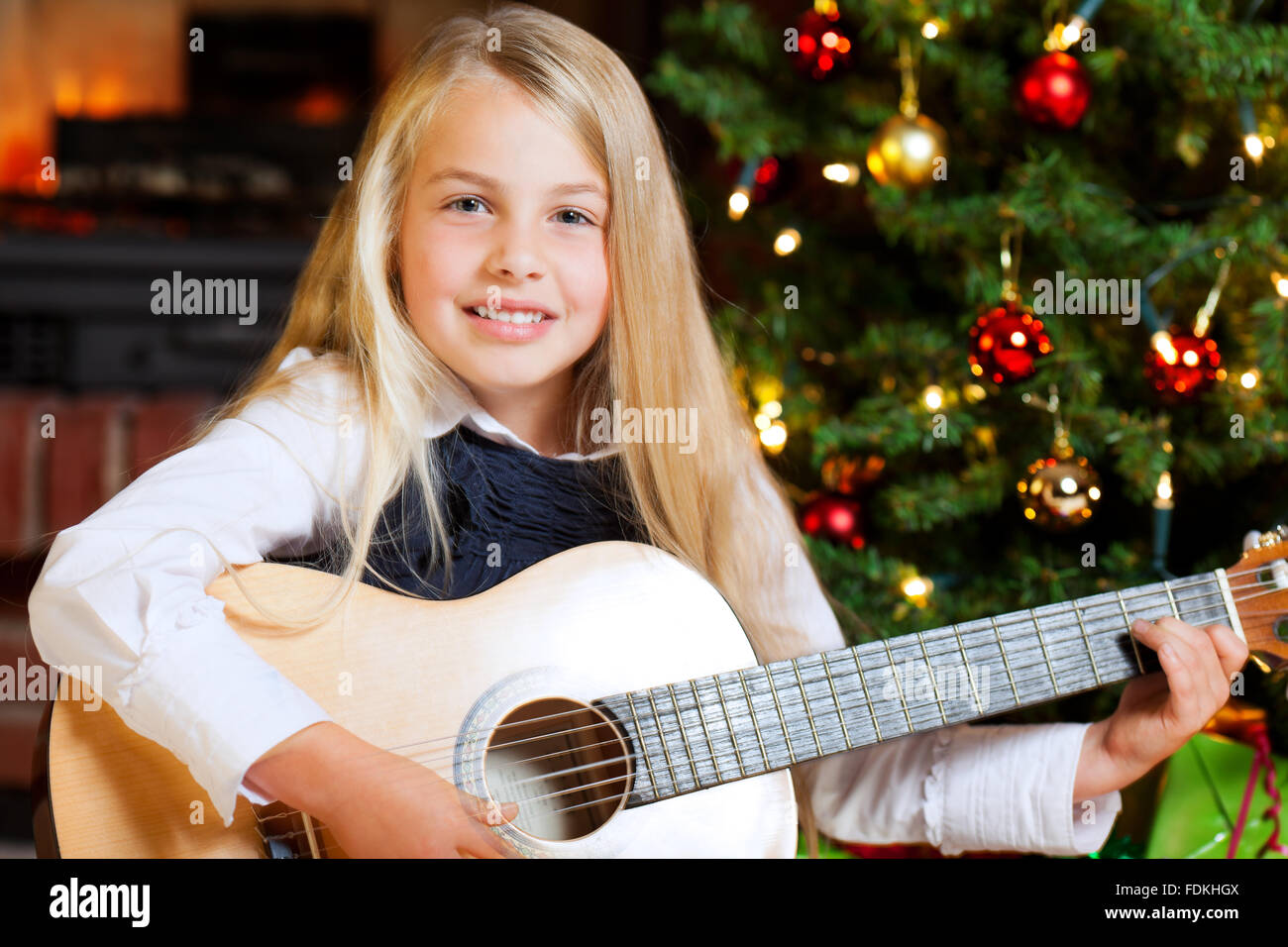 girl,christmas,playing guitar,christmas song Stock Photo - Alamy
