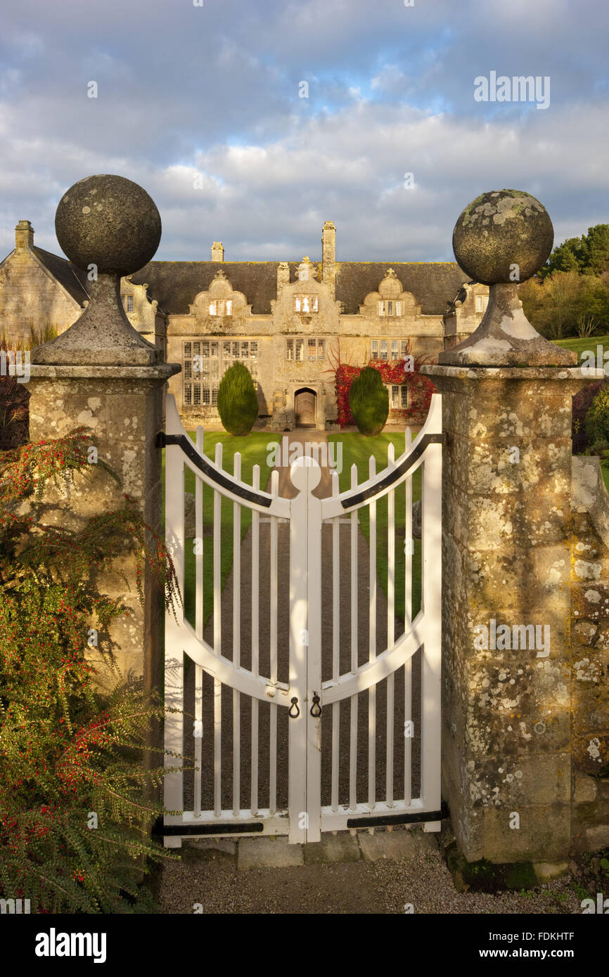 The east front seen beyond the gates at Trerice, Cornwall. This facade ...