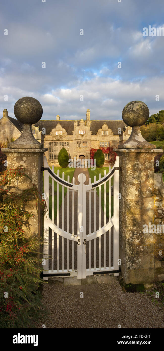 The east front seen beyond the gates at Trerice, Cornwall. This facade ...