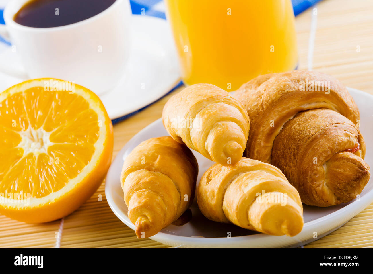 Croissants and cup of coffee on breakfast table Stock Photo - Alamy