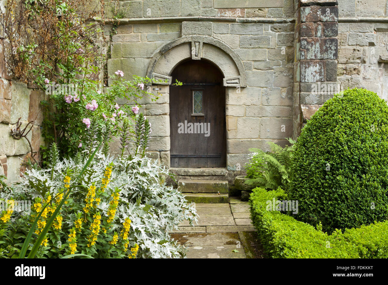 View across the herb knot garden in July towards the medieval range of ...
