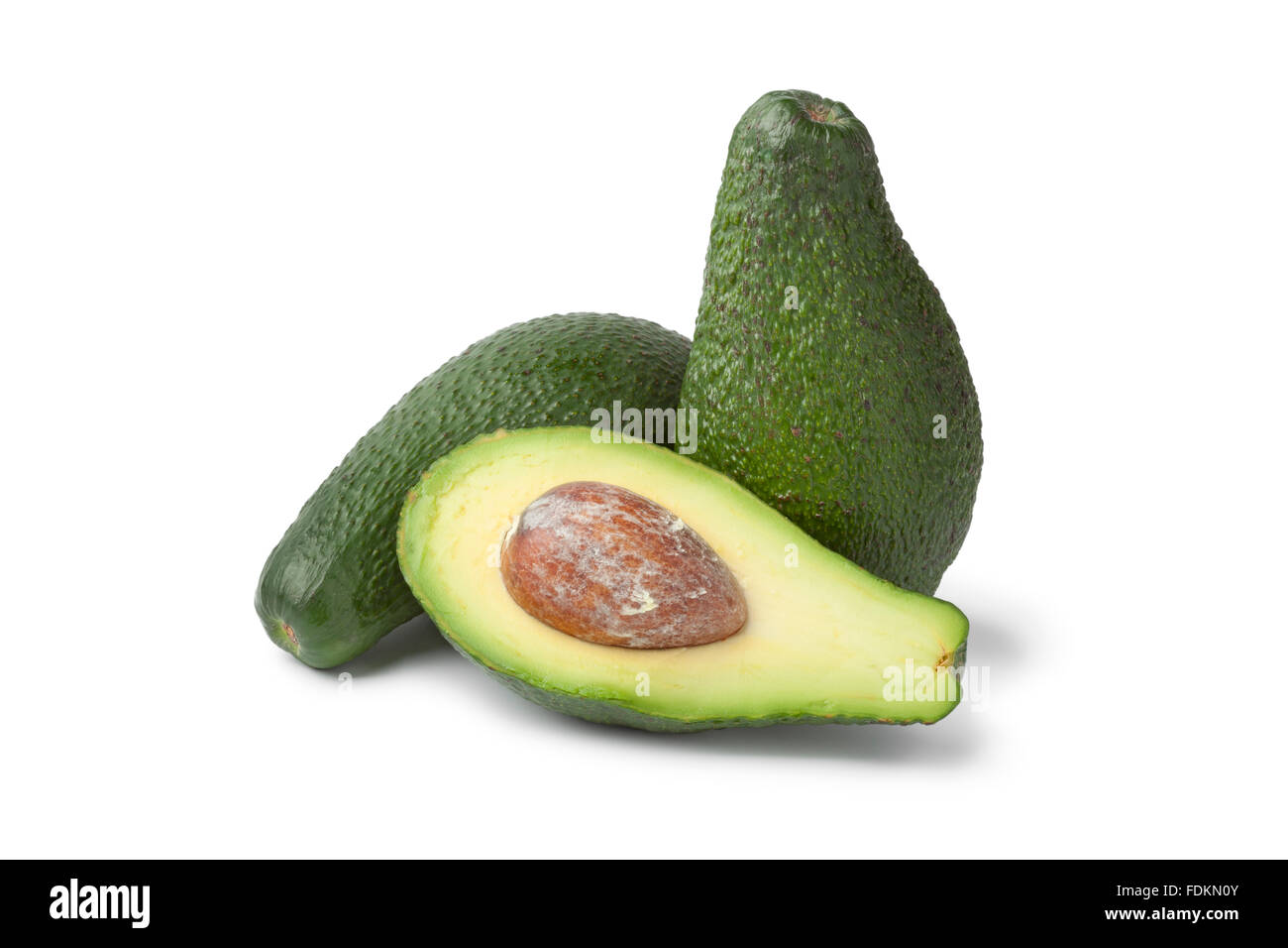Whole and half fresh avocados on white background Stock Photo - Alamy