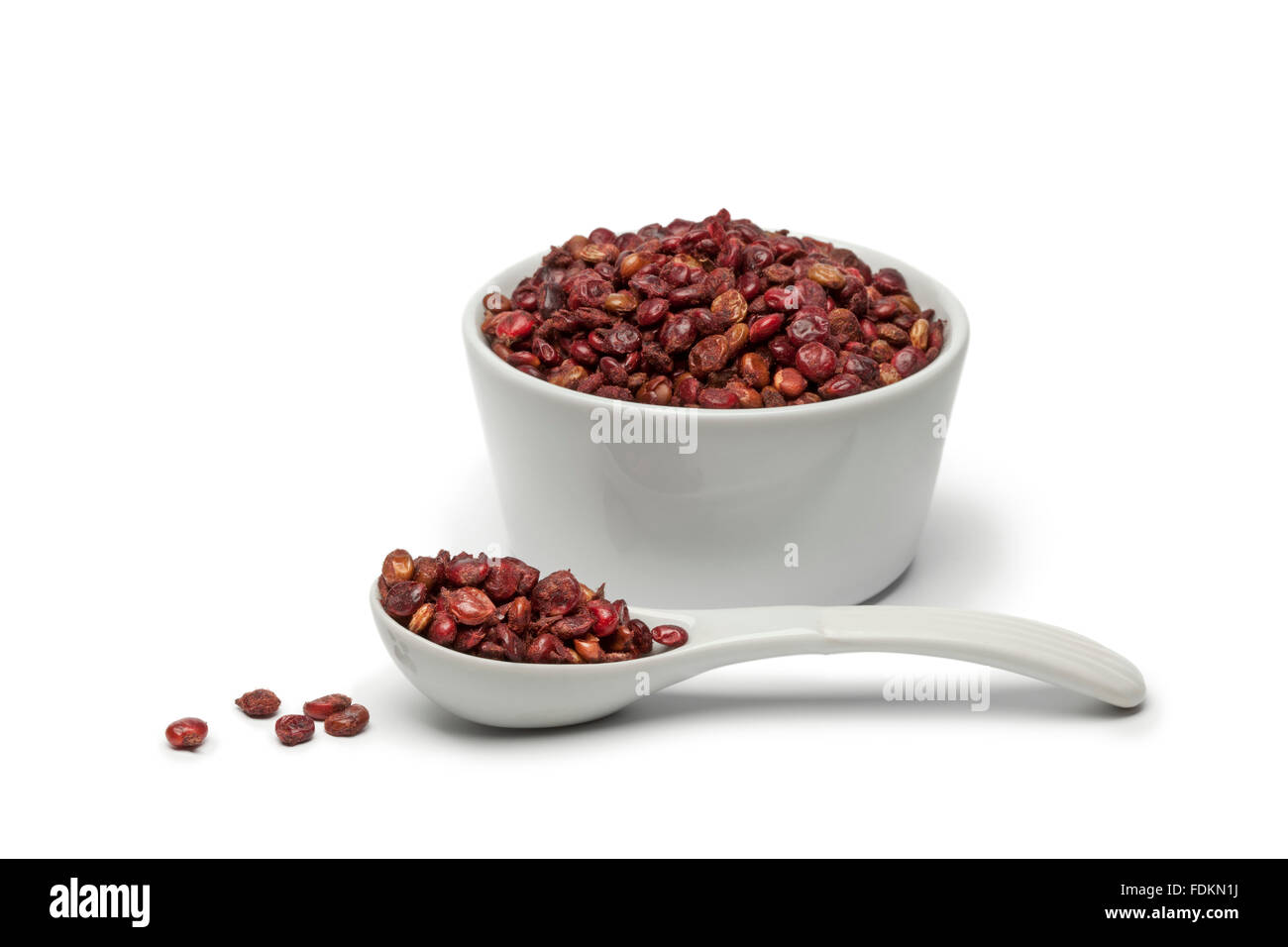 Dried Sumac berries in a cup and spoon on white background Stock Photo ...