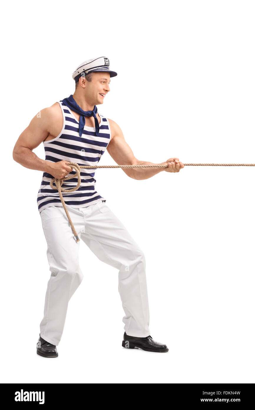Full length profile shot of a young male sailor pulling a rope isolated ...