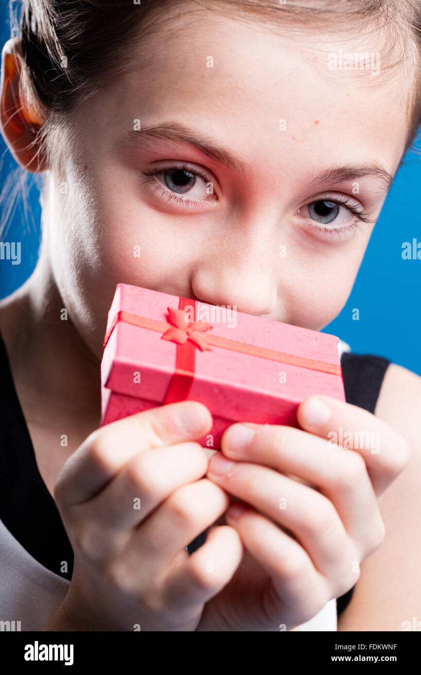 little girl shy and happy with a red or pink gift box Stock Photo - Alamy
