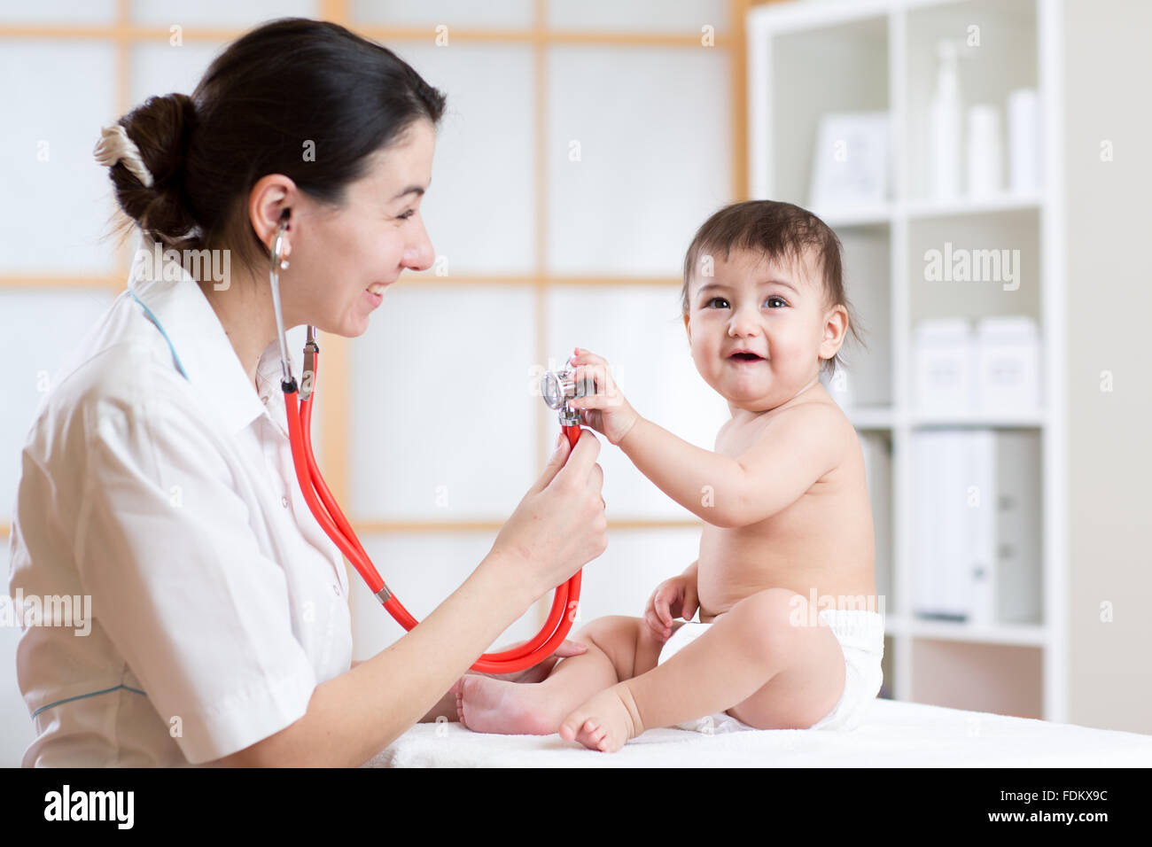 female pediatrician examining of toddler kid with stethoscope Stock ...