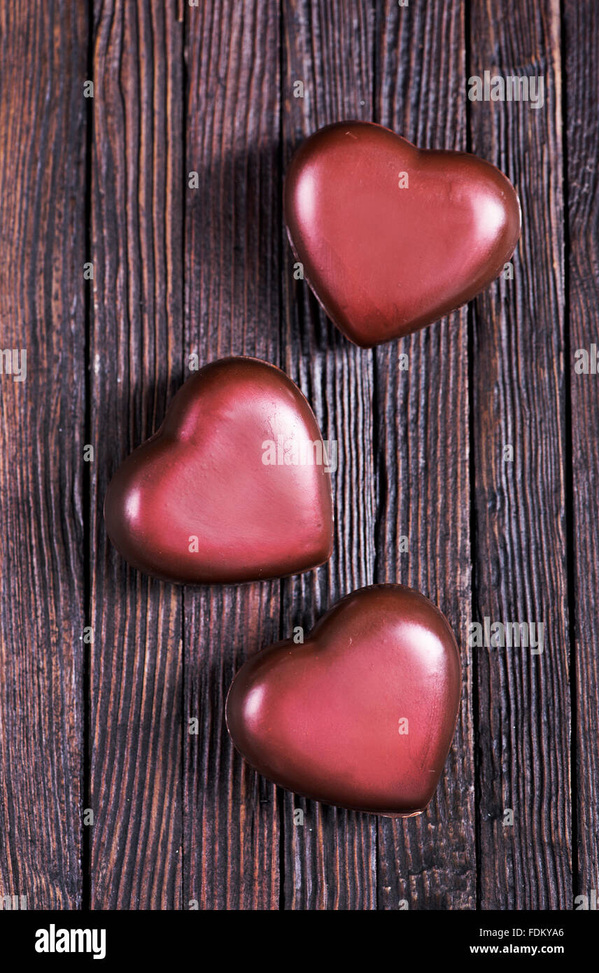 chocolate hears on the wooden table, chocolate candy Stock Photo - Alamy