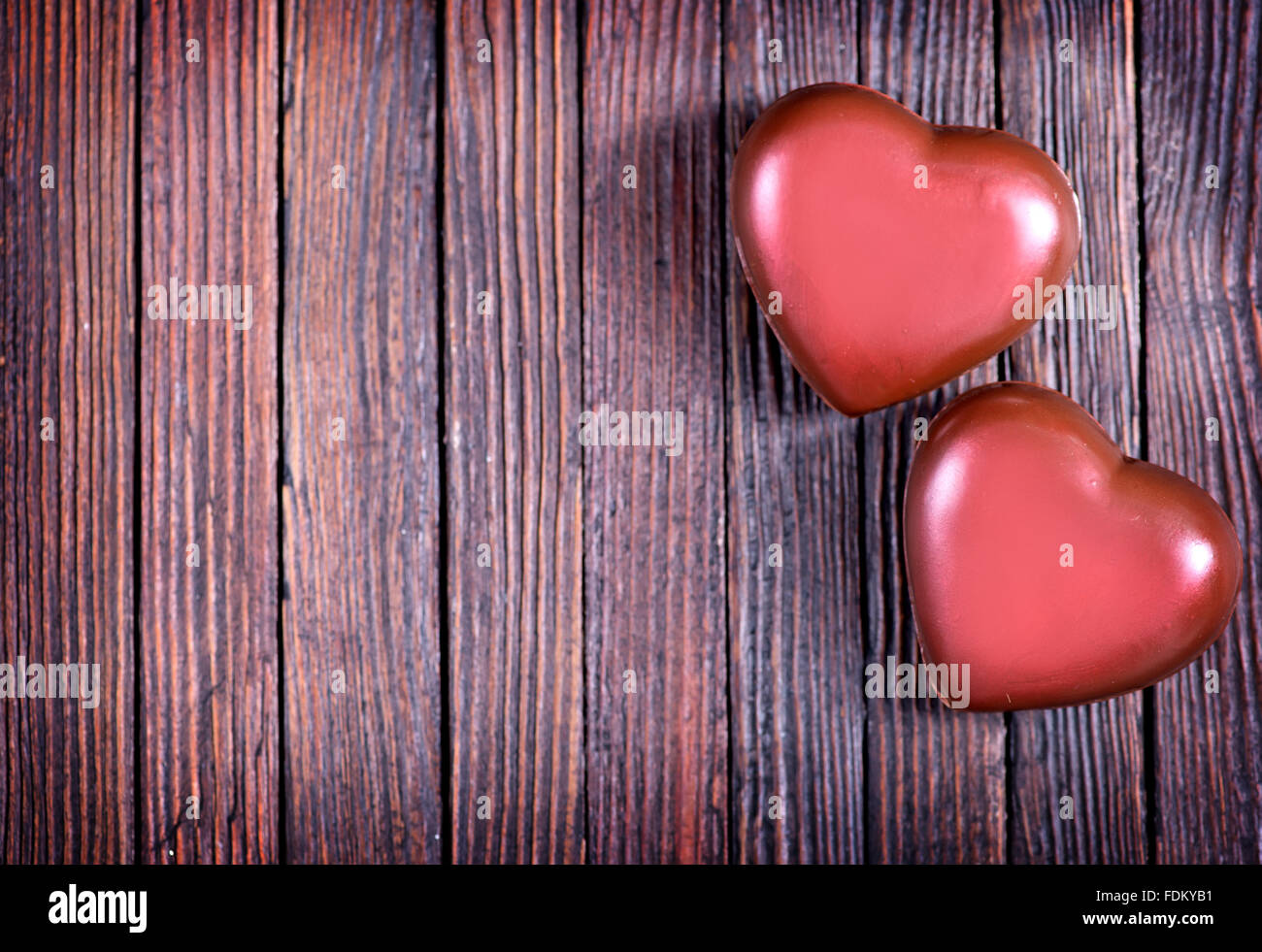 chocolate hears on the wooden table, chocolate candy Stock Photo - Alamy