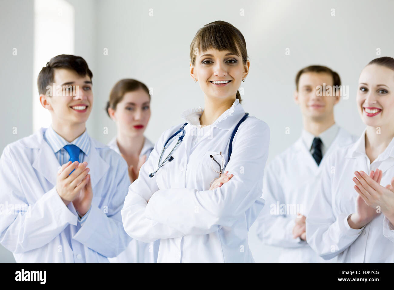 Attractive female doctor in uniform congratulated by colleagues Stock ...