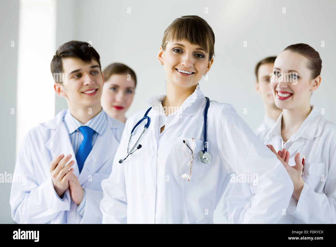 Attractive female doctor in uniform congratulated by colleagues Stock ...