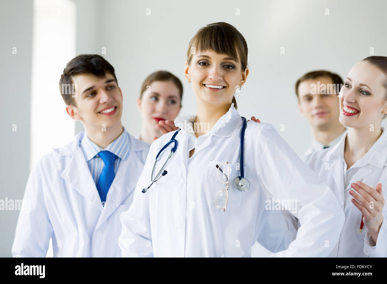 Attractive female doctor in uniform congratulated by colleagues Stock ...