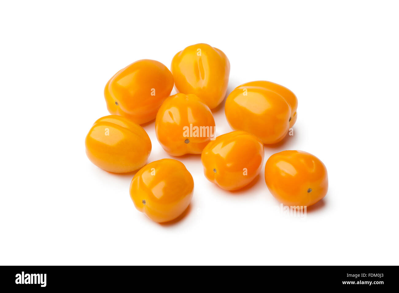 Heap of yellow baby tomatoes on white background Stock Photo - Alamy