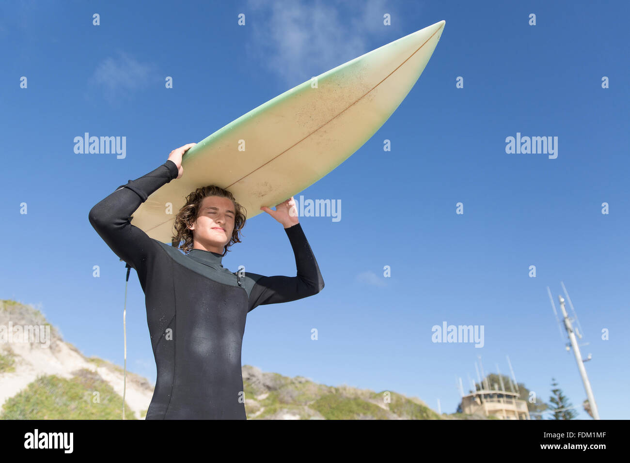 A surfer with his surfboard at the beach Stock Photo - Alamy