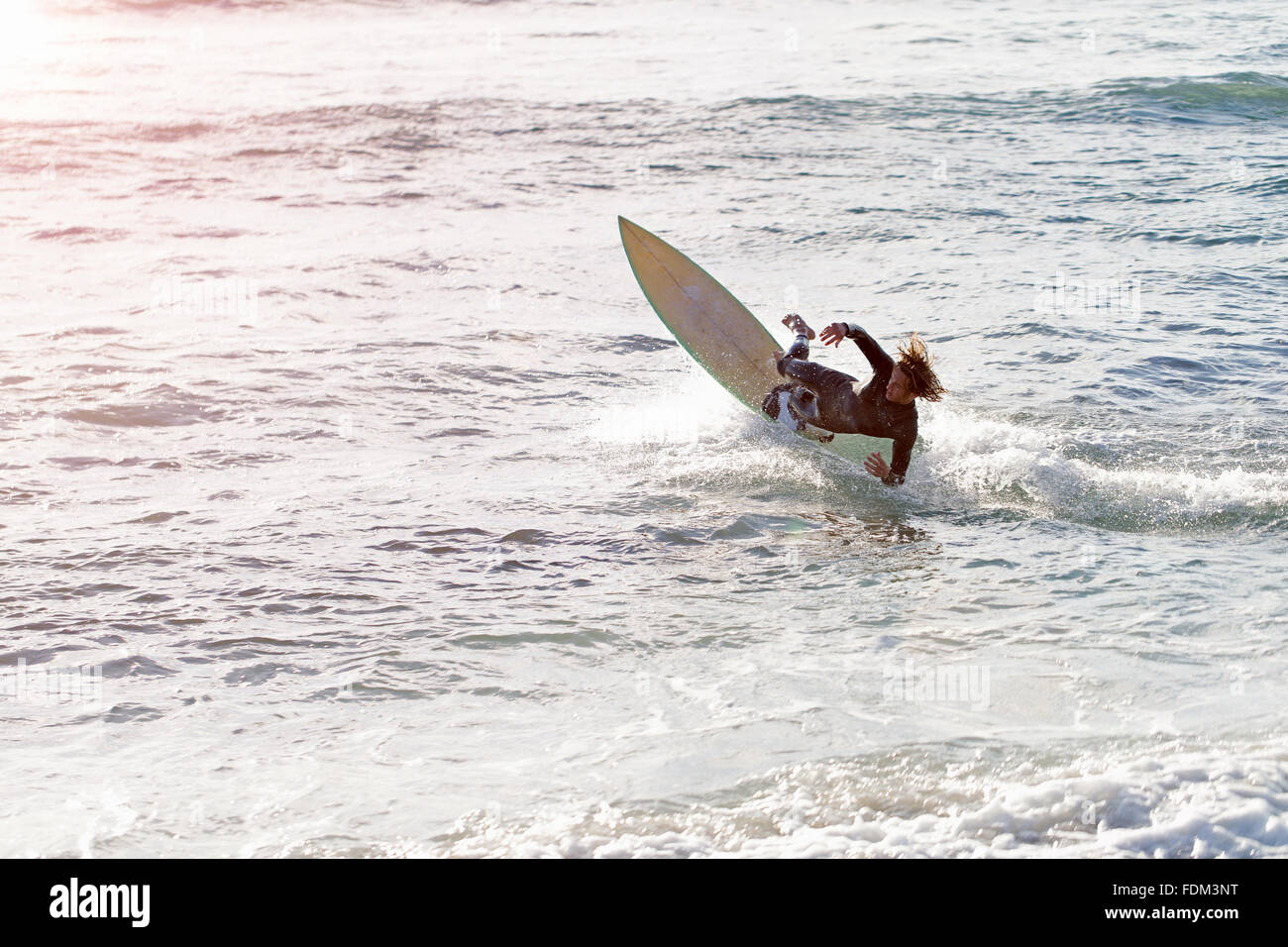 A surfer with his surfboard at the beach Stock Photo - Alamy