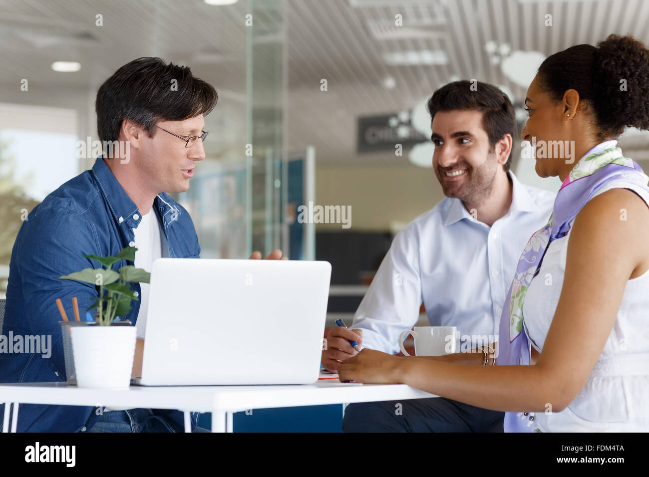 Collegues working together in an office Stock Photo - Alamy