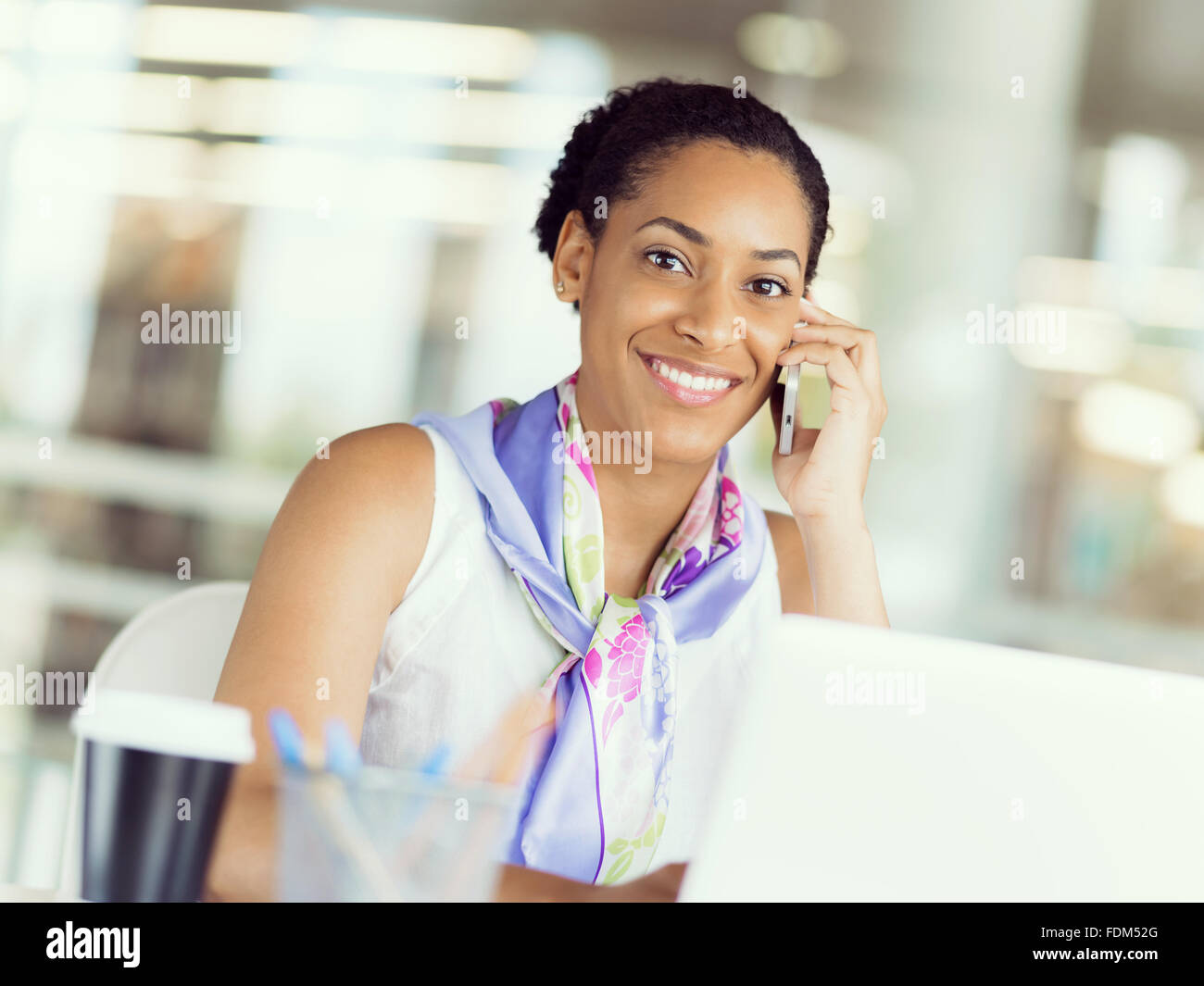 Young business woman talking over phone in front of her laptop Stock ...