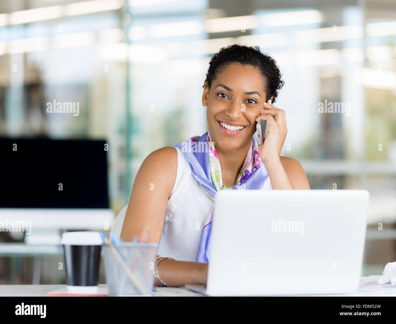 Young business woman talking over phone in front of her laptop Stock ...
