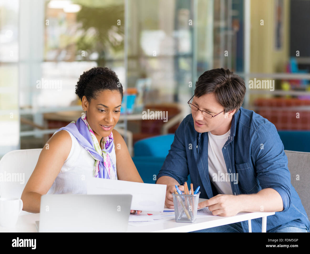 Shot of a young office worker getting some assistance from her manager ...