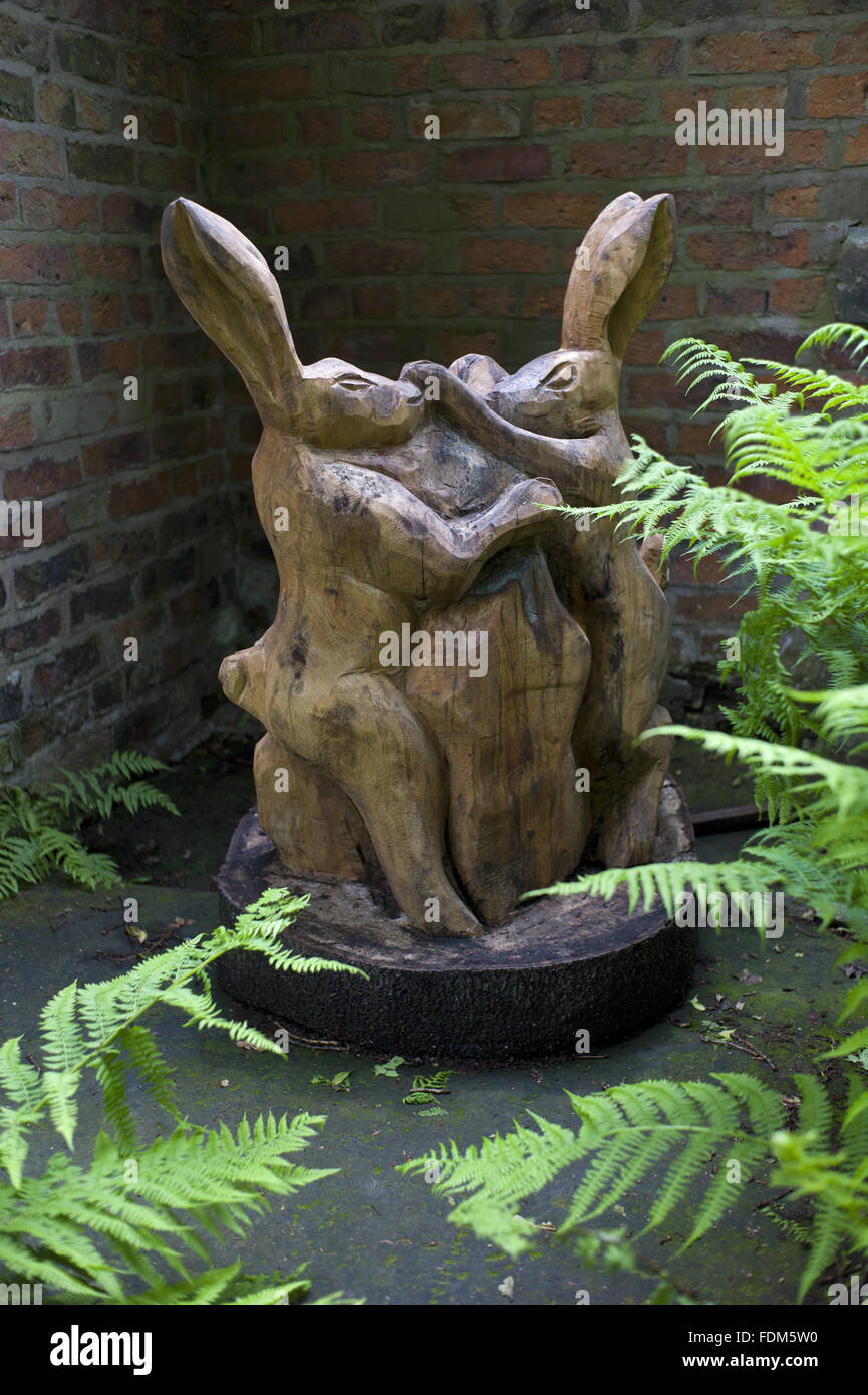 Wooden sculpture of hares boxing, part of a trail in the garden at Hare ...