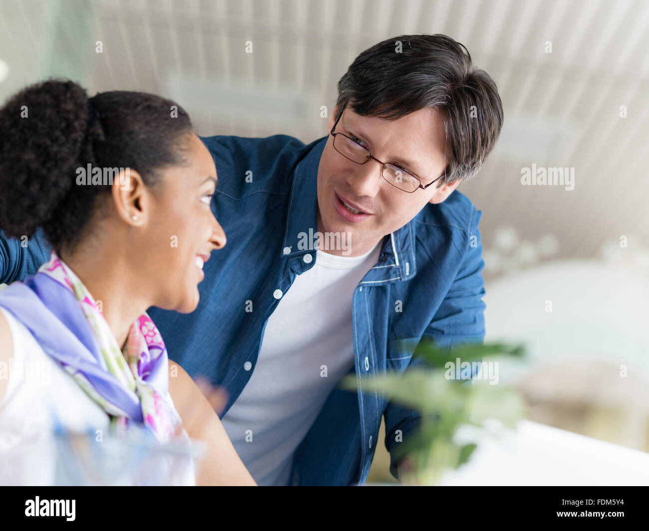 Shot of a young office worker getting some assistance from her manager ...