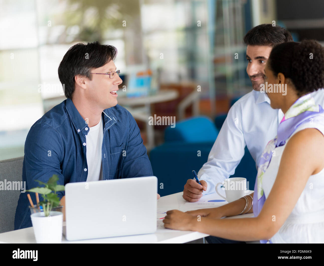 Collegues working together in an office Stock Photo - Alamy