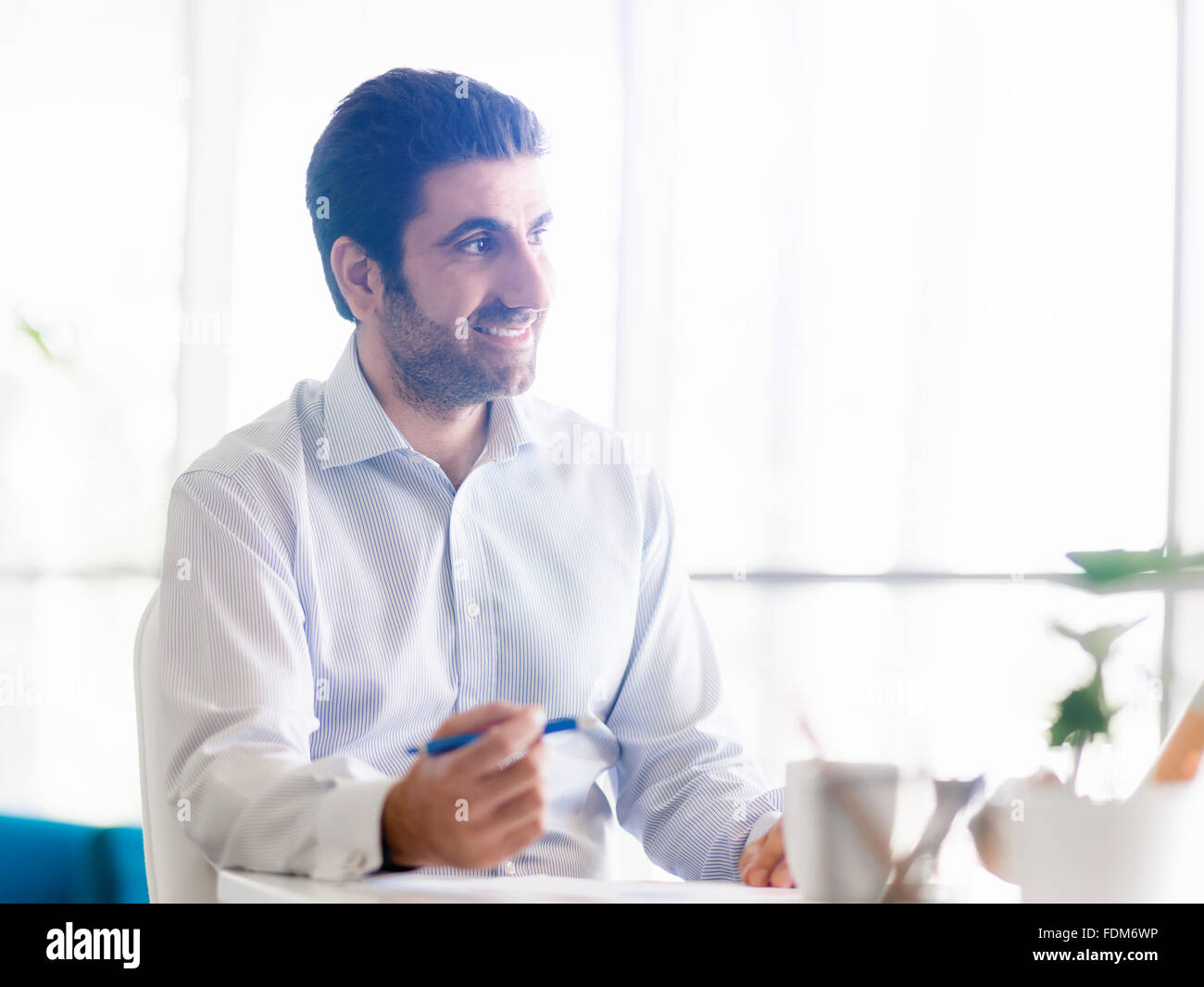 Young happy professional in office Stock Photo - Alamy