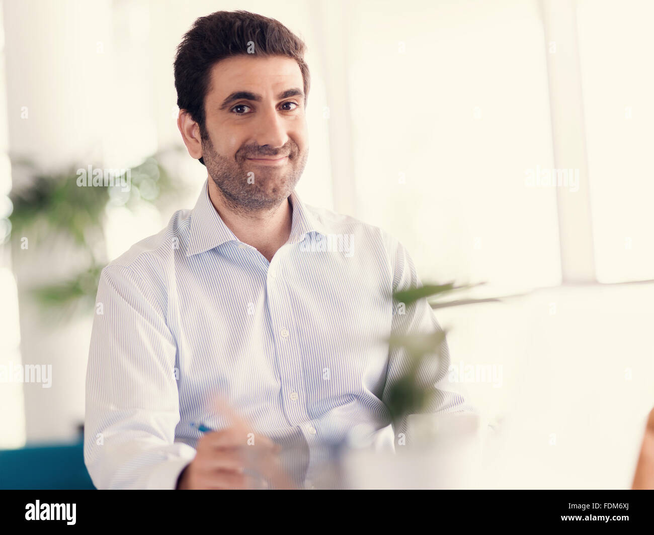 Young happy professional in office Stock Photo - Alamy