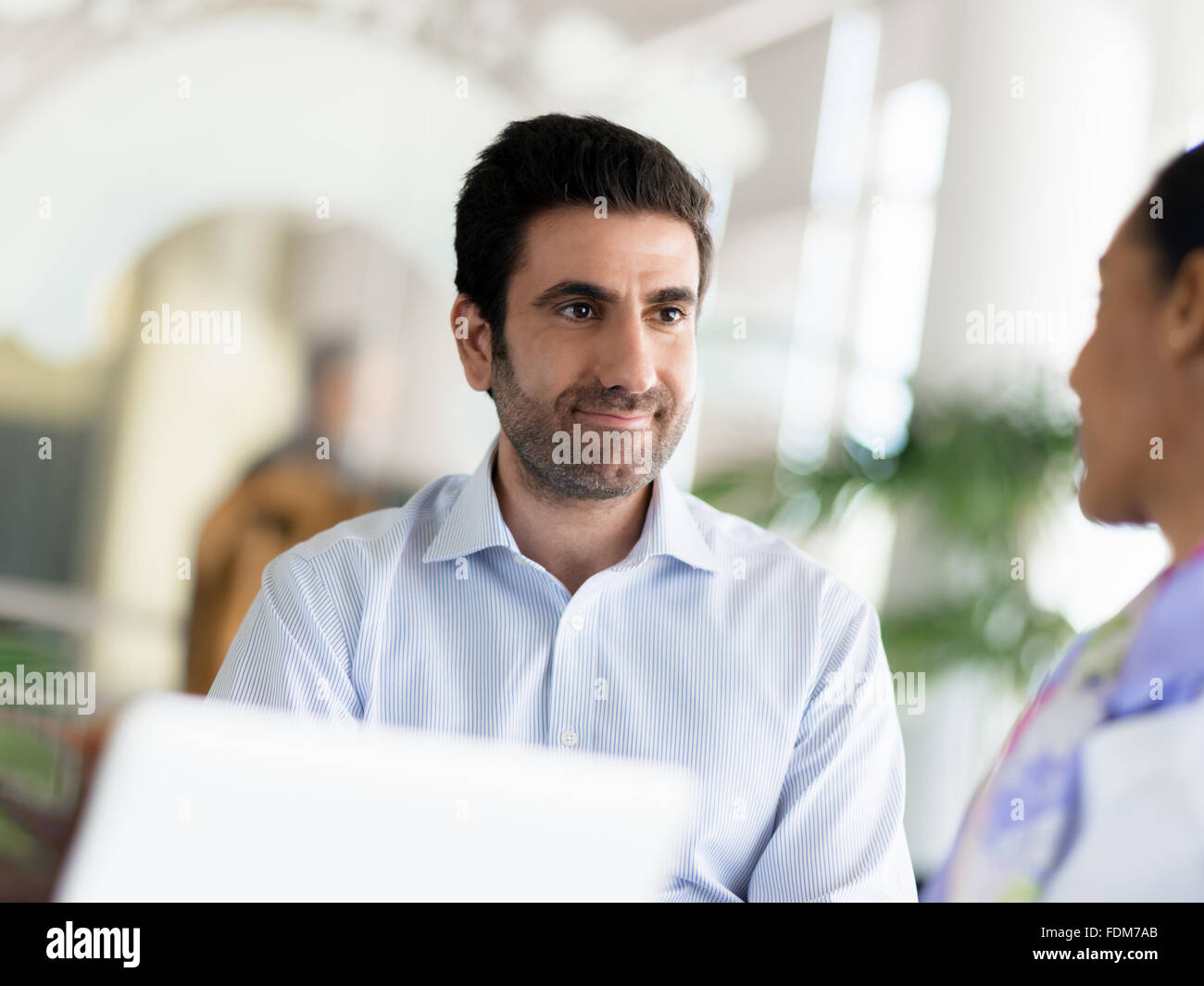 Young happy professional in office Stock Photo - Alamy
