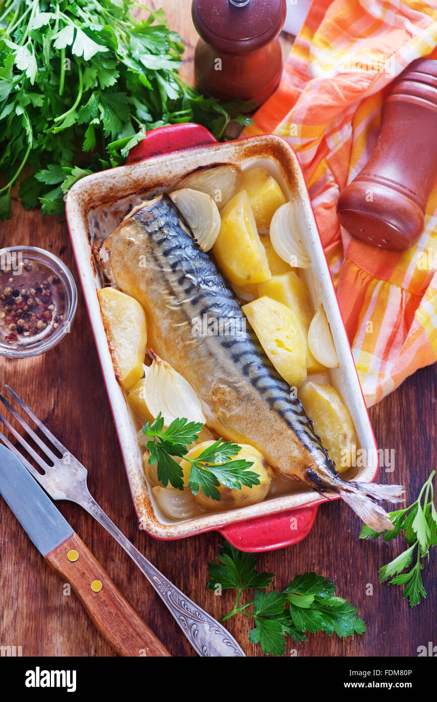 baked potato with baked fish for dinner Stock Photo - Alamy