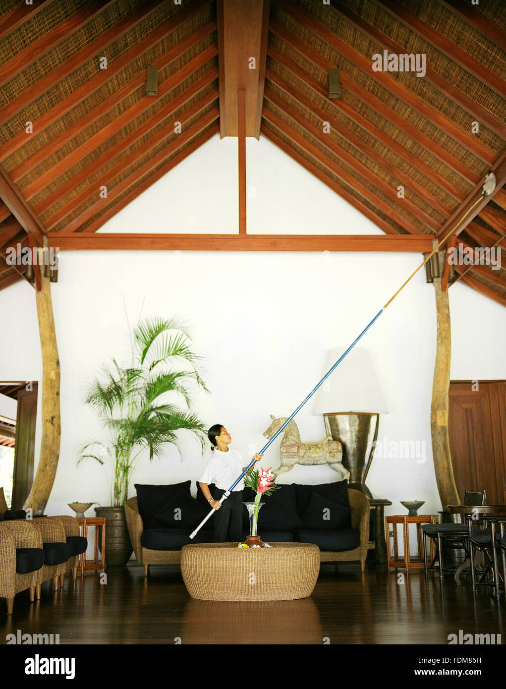 A maid cleans the rafters inside the reception area at The Farm at San ...