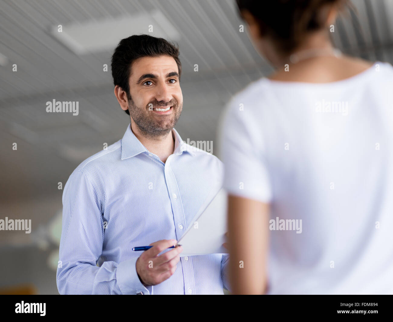 Two collegues having a talk in office Stock Photo - Alamy