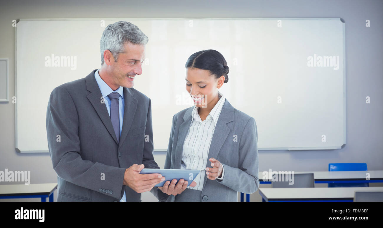 Composite image of business people using tablet computer Stock Photo ...