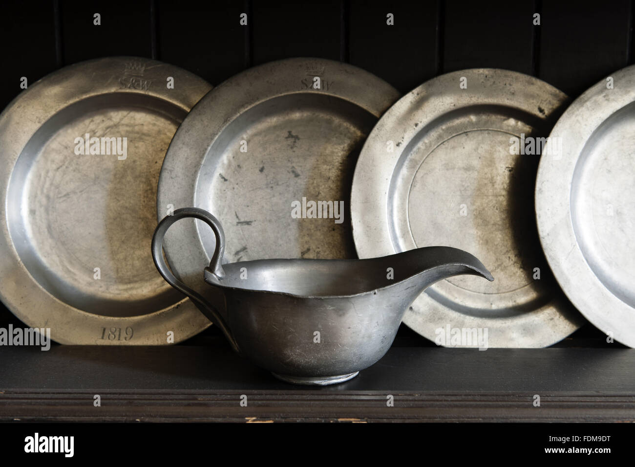 Pewterware in the cabinet in the Kitchen at Dunham Massey, Cheshire ...