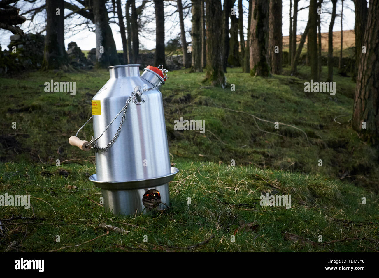 A Kelly Kettle lit and burning in winter woodland Stock Photo - Alamy