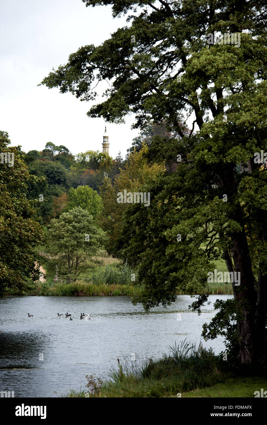 A view over the lake with a distant view of the Cobham Monument at ...