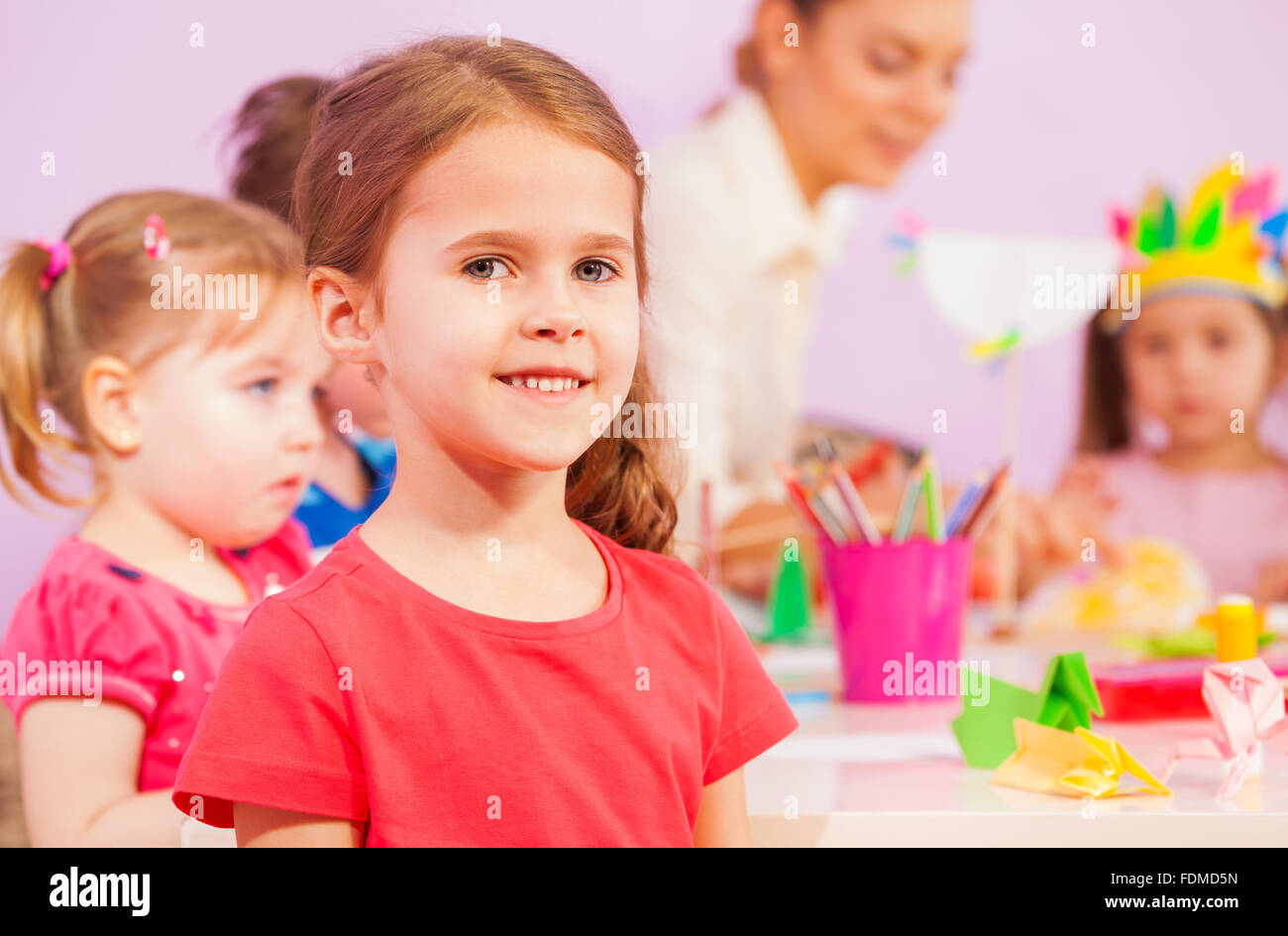 Smiling little girl in kindergarten classroom Stock Photo - Alamy