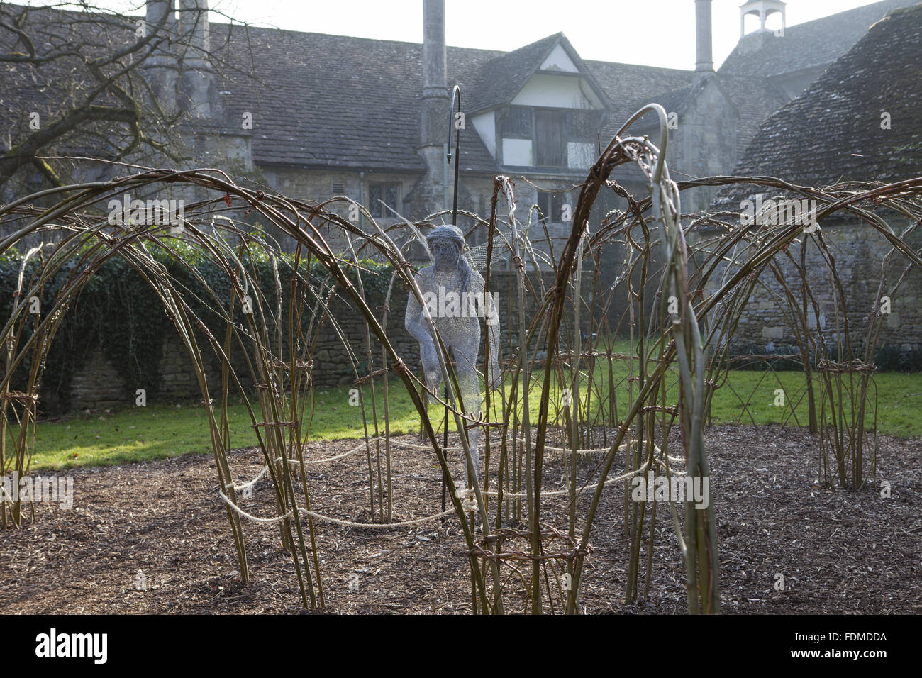 Woven willow circle in spring at Lacock Abbey, Wiltshire. A wire ...