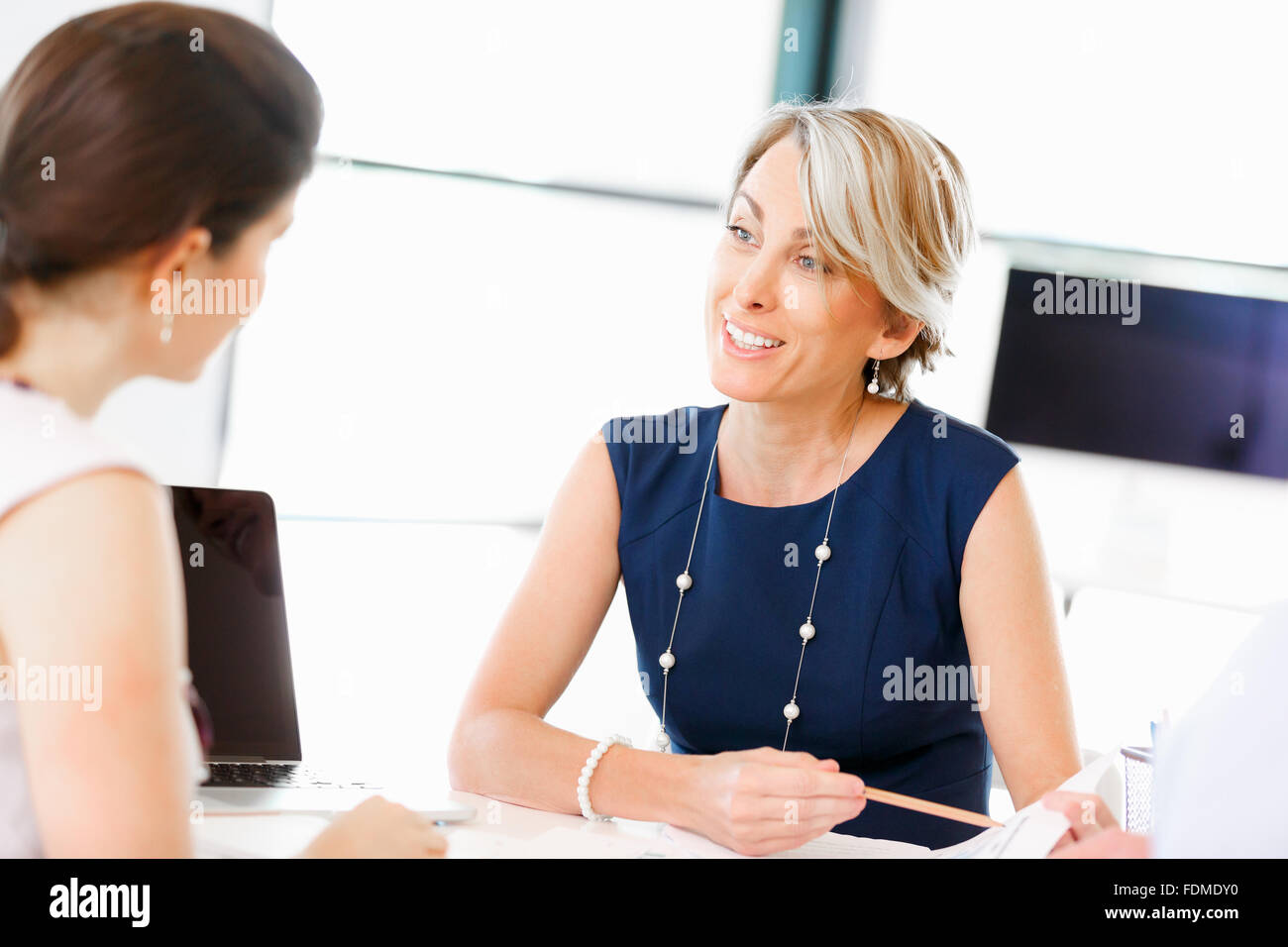 Female manager assessing work of her employees Stock Photo - Alamy