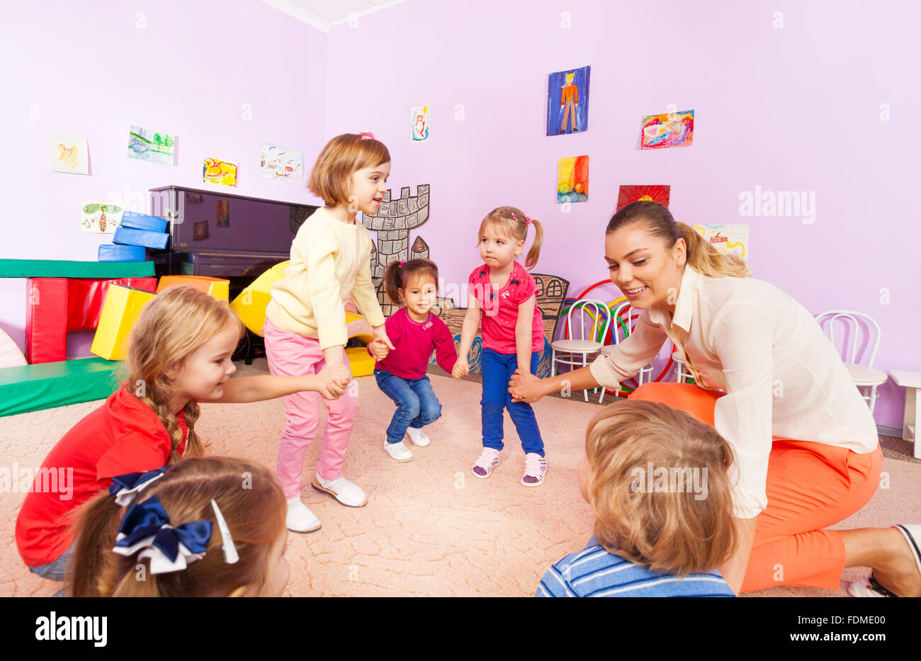 Little children boys, girls squat play roundelay Stock Photo - Alamy