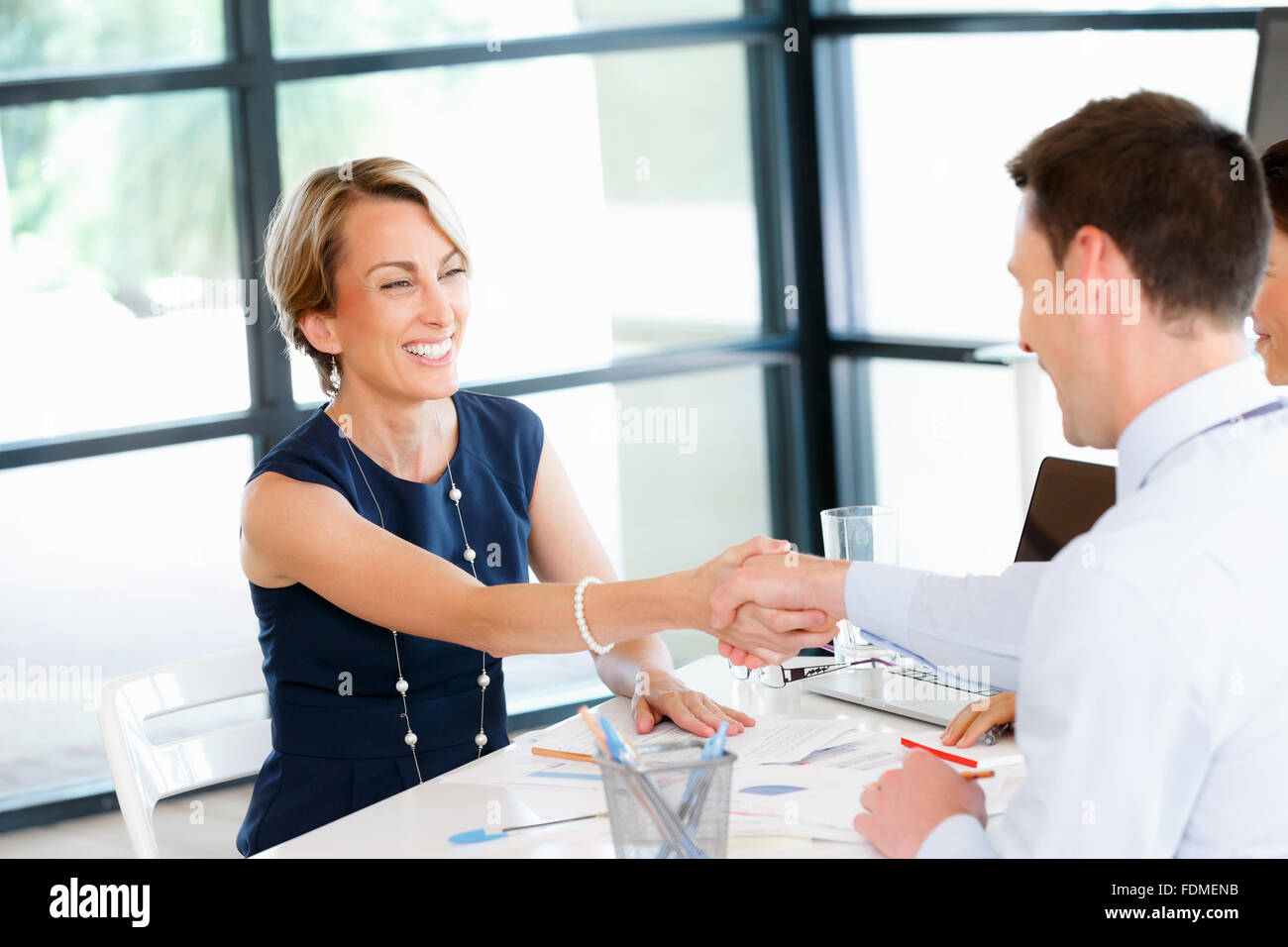 Business woman shaking hands with someone Stock Photo - Alamy