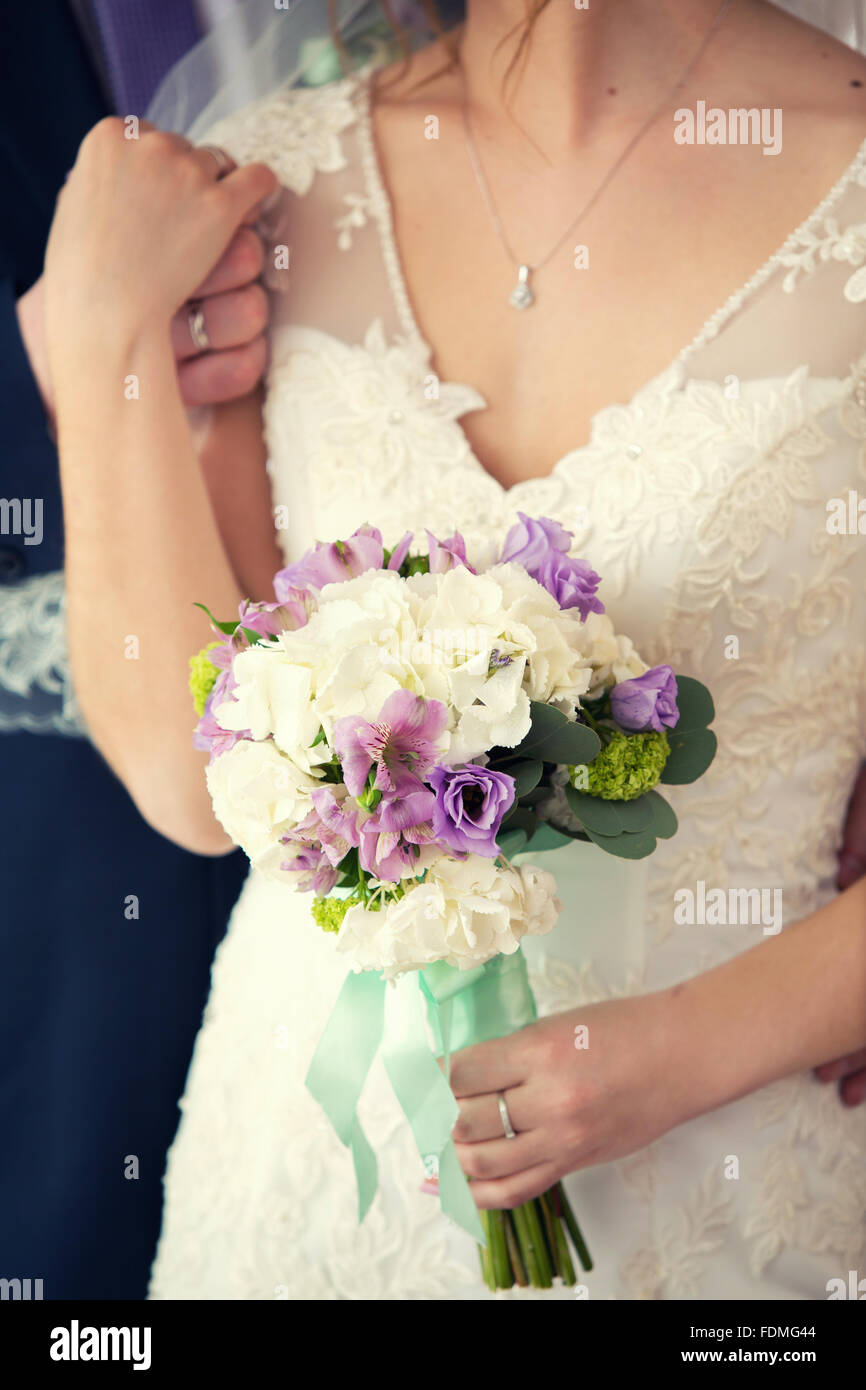 bridal bouquet of violet color in hands Stock Photo - Alamy