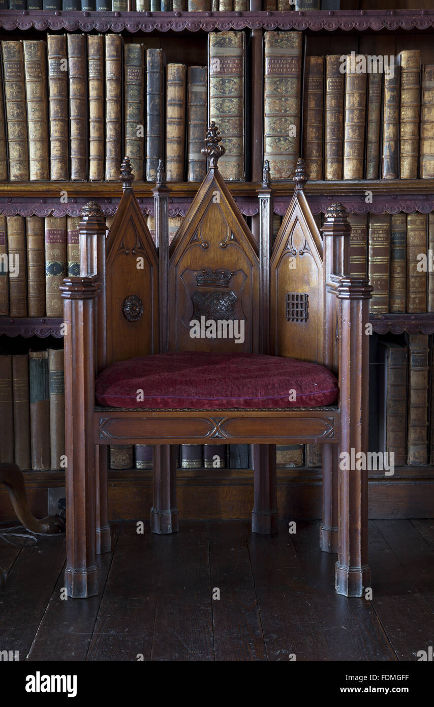 A chair and bookcase in the Library in the East Wing at Chirk Castle ...