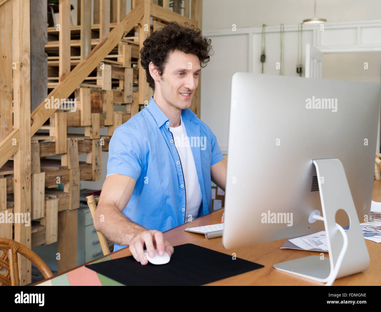 Man in casual wear working in office Stock Photo - Alamy