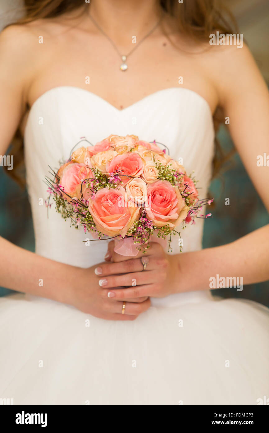bridal bouquet of pink color in hands Stock Photo - Alamy