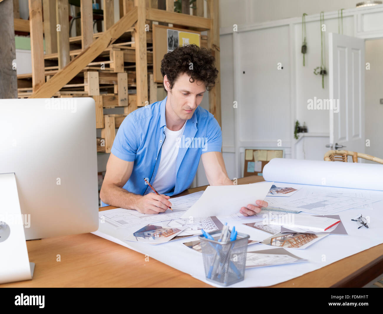 Man working with drafts in office Stock Photo - Alamy