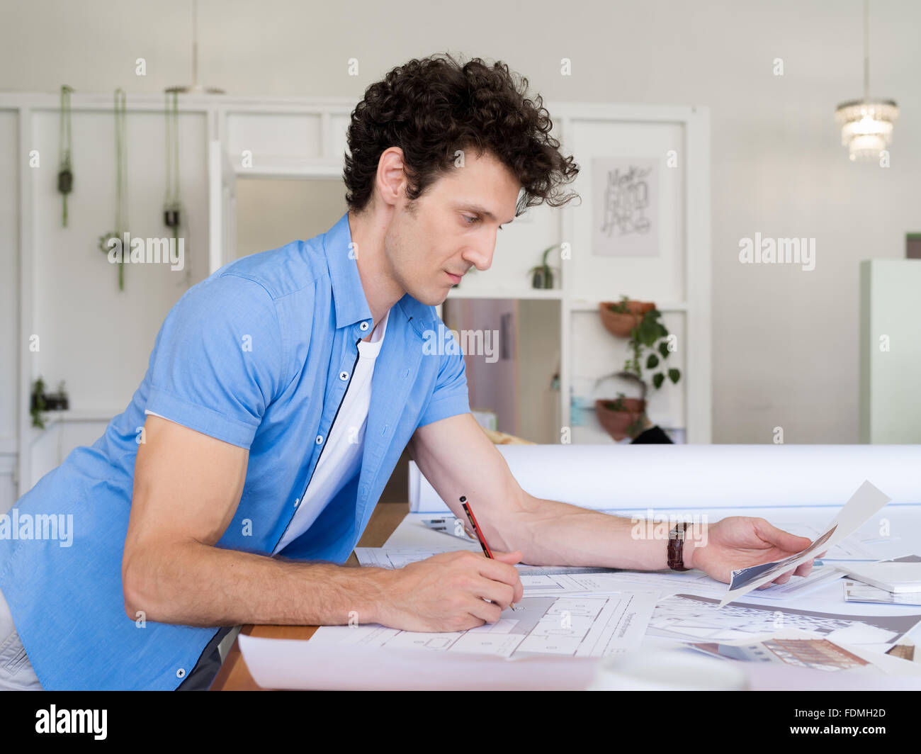 Man working with drafts in office Stock Photo - Alamy