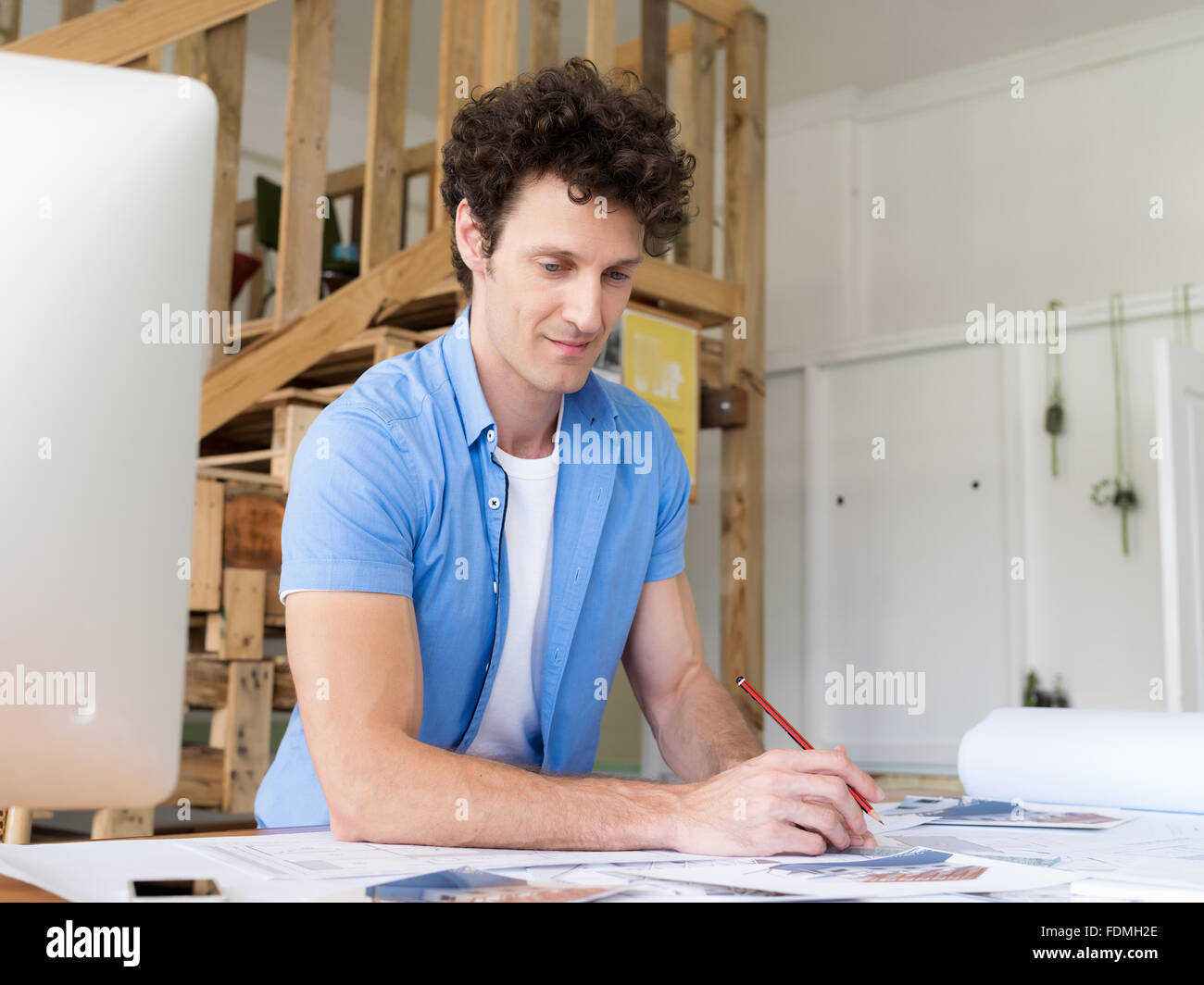 Man working with drafts in office Stock Photo - Alamy