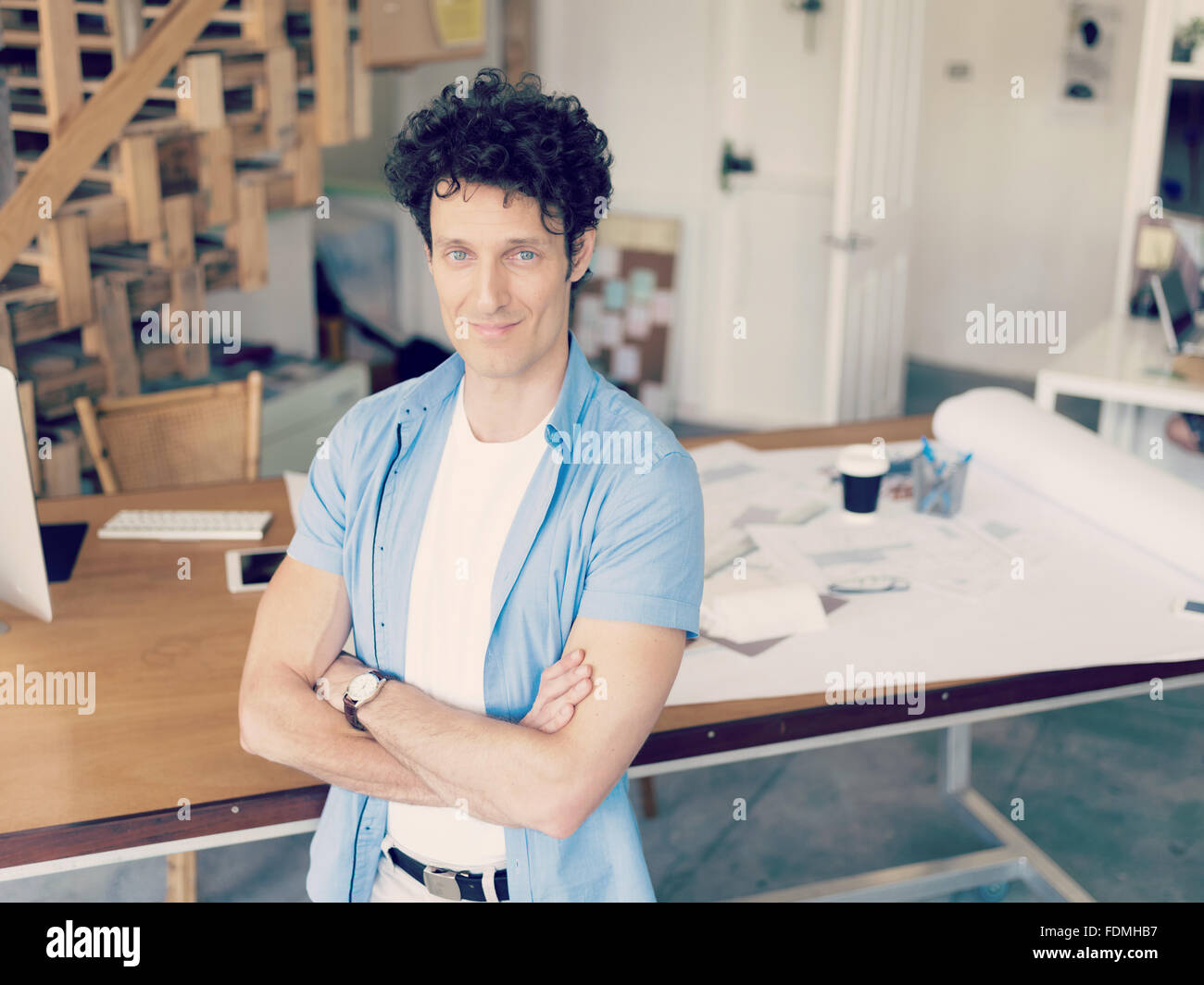 Man standing next to his desk in office Stock Photo - Alamy
